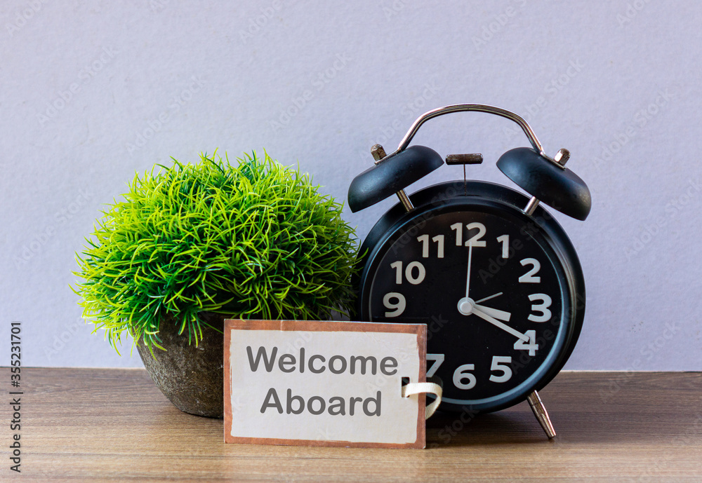 WELCOME ABOARD text on label with keyboard,clock and green grass Stock ...