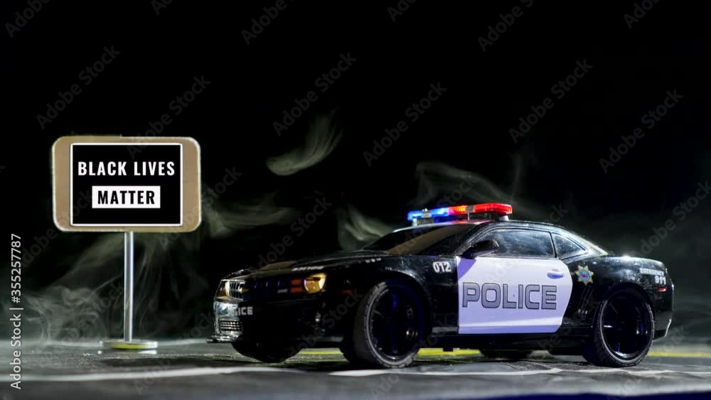 Black Lives Matter sign / protest / Police car cruiser with flashing ...