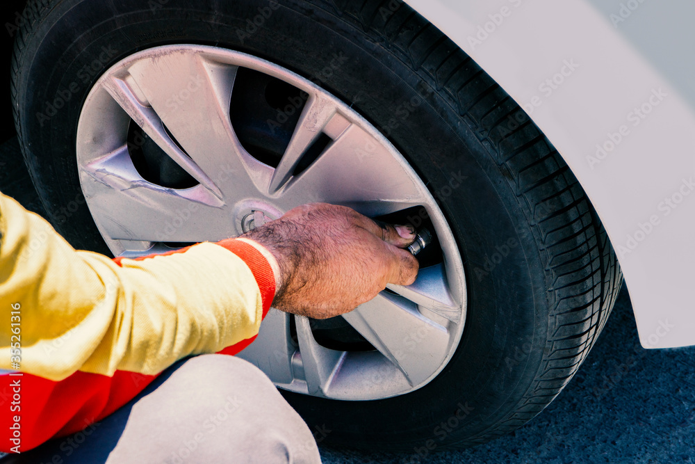 close up hand man car parking a check the tire fill up the air for safe ...