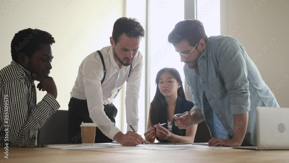 Happy diverse male executive team mates talking working together doing ...