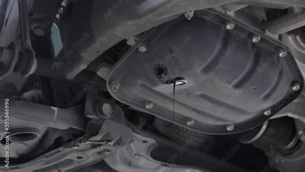 Engine oil dripping from hole in sump Stock ビデオ | Adobe Stock