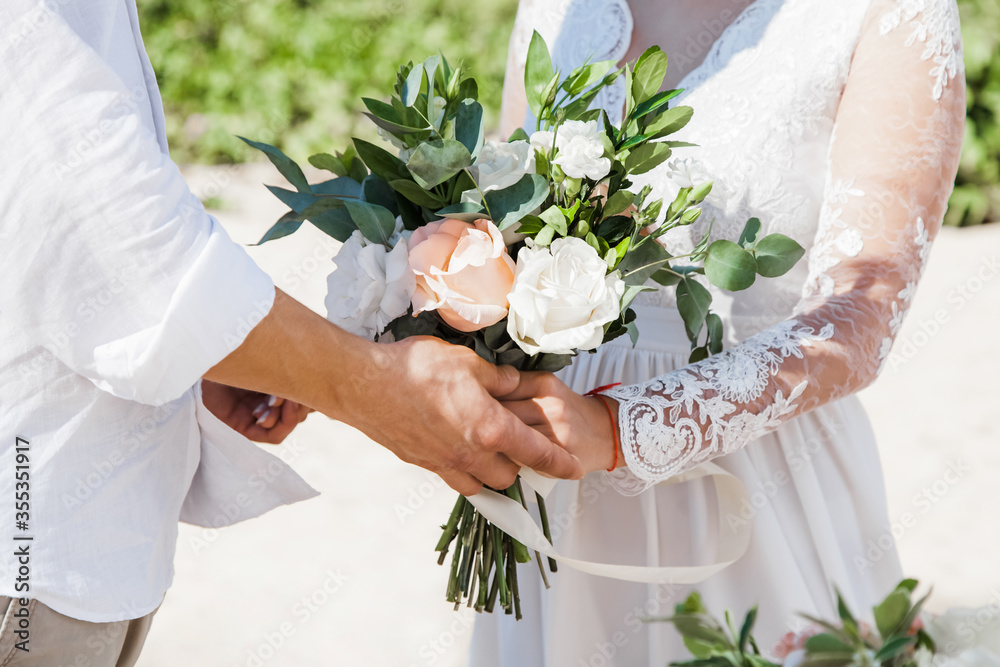 Newlyweds at the wedding romantic couple holding hands during ...