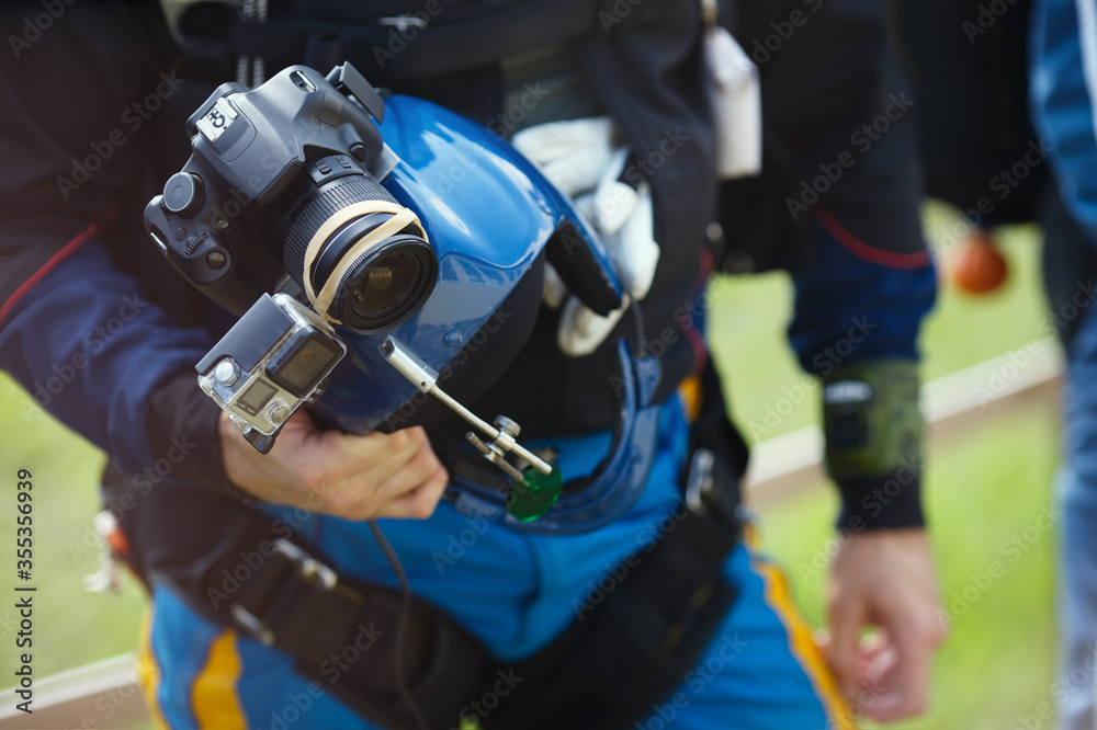 Parachute helmet with an installed DSLR camera in the hands of a ...