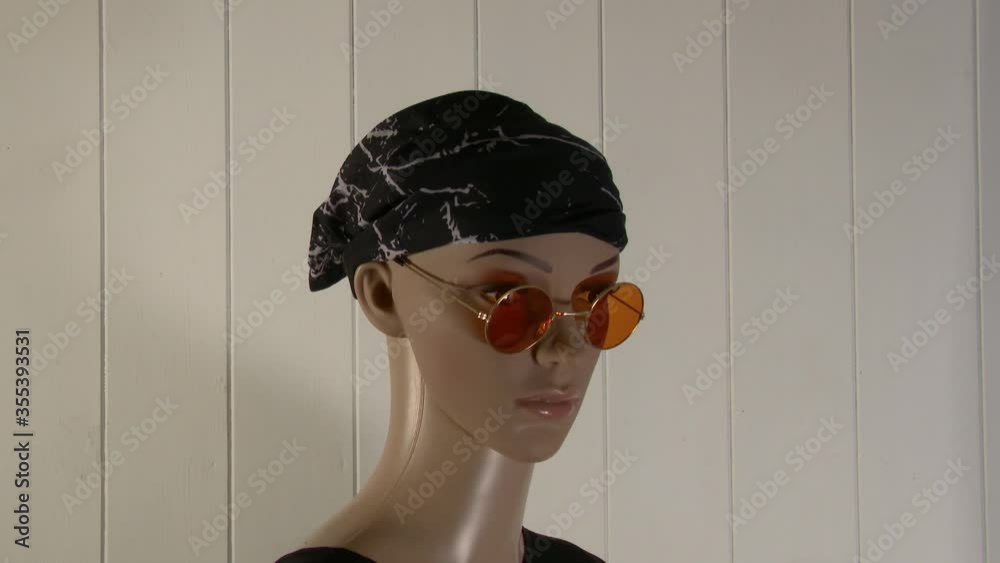 Female mannequin poses close-up for fashion video with sunglasses and ...