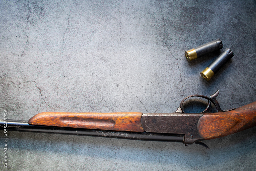 Old hunting rifles and ammunition on a dark background with a top view ...
