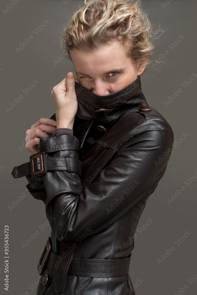 model woman who emotionally and sensually poses in a dark leather ...