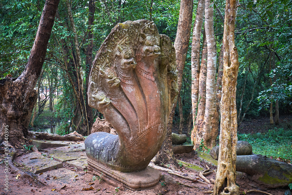 Ancient seven headed snake stone statue at the Beng Mealea khmer temple ...