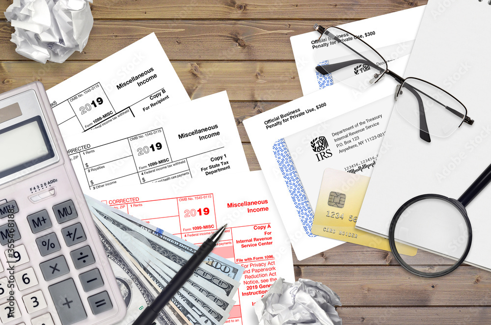 IRS form 1099-MISC Miscellaneous income lies on flat lay office table ...
