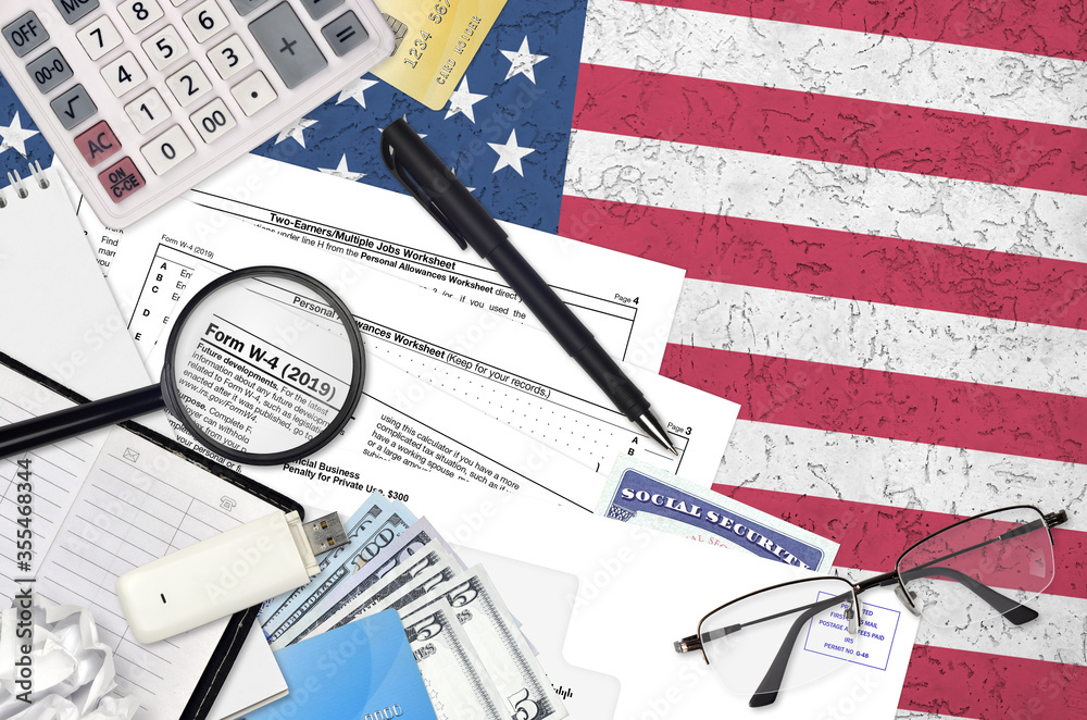 IRS form w-4 Employees Withholding Certificate lies on flat lay office ...