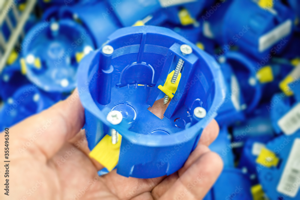 Blue plastic enclosure for installation of electrical outlet. Wiring in ...