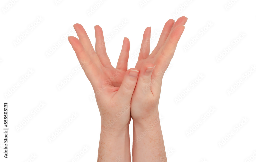 Freckled white hands, heels of hands together, fingers splayed and ...