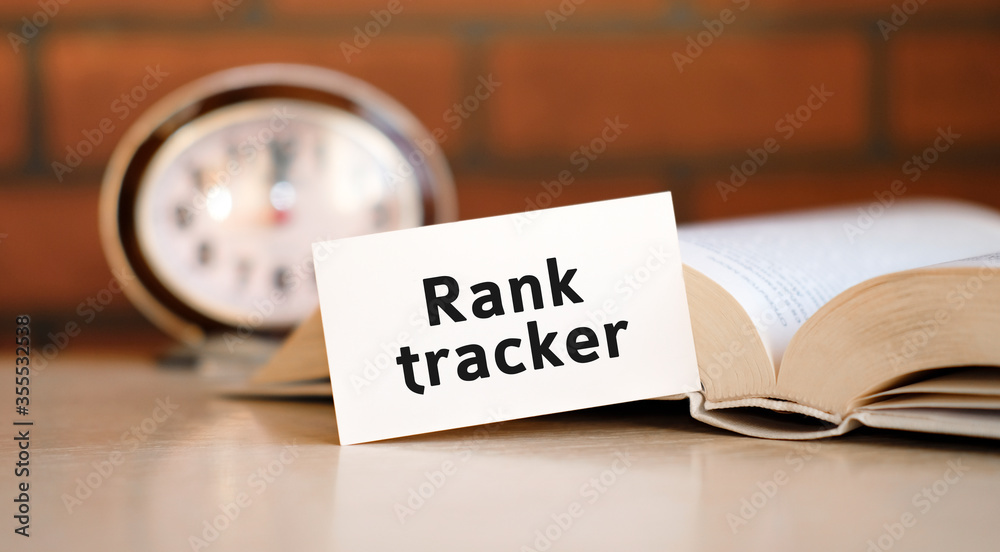Rank tracker - concept text on a white background with a clock and an ...