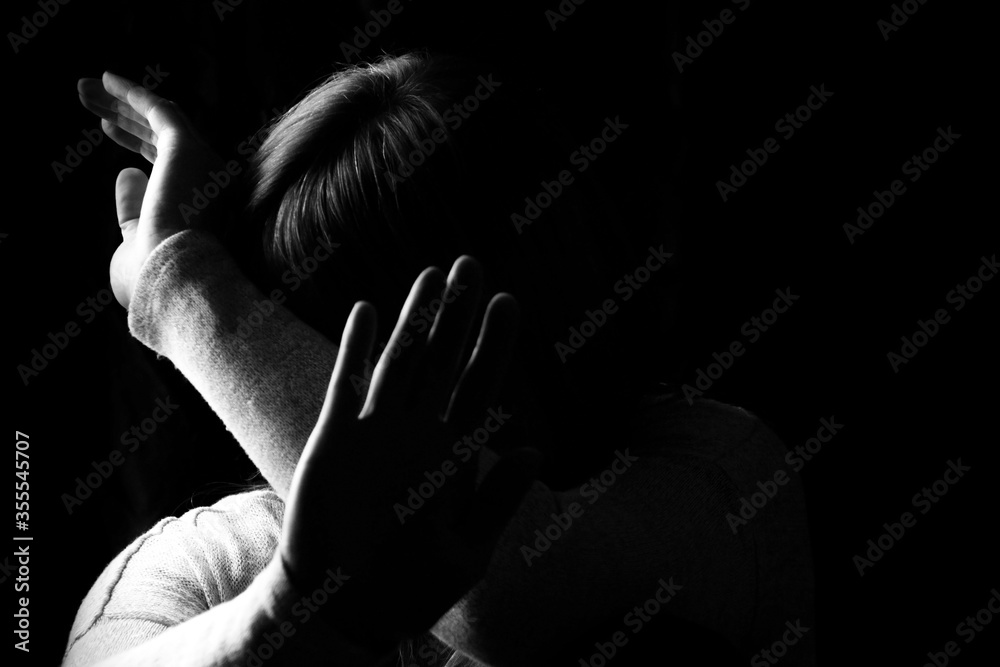 Black and white portrait of a woman hiding her face with hands. Stop ...