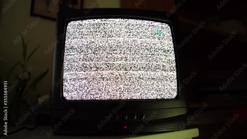 Old vintage TV transmission in dark room, flicking retro TV screen with ...