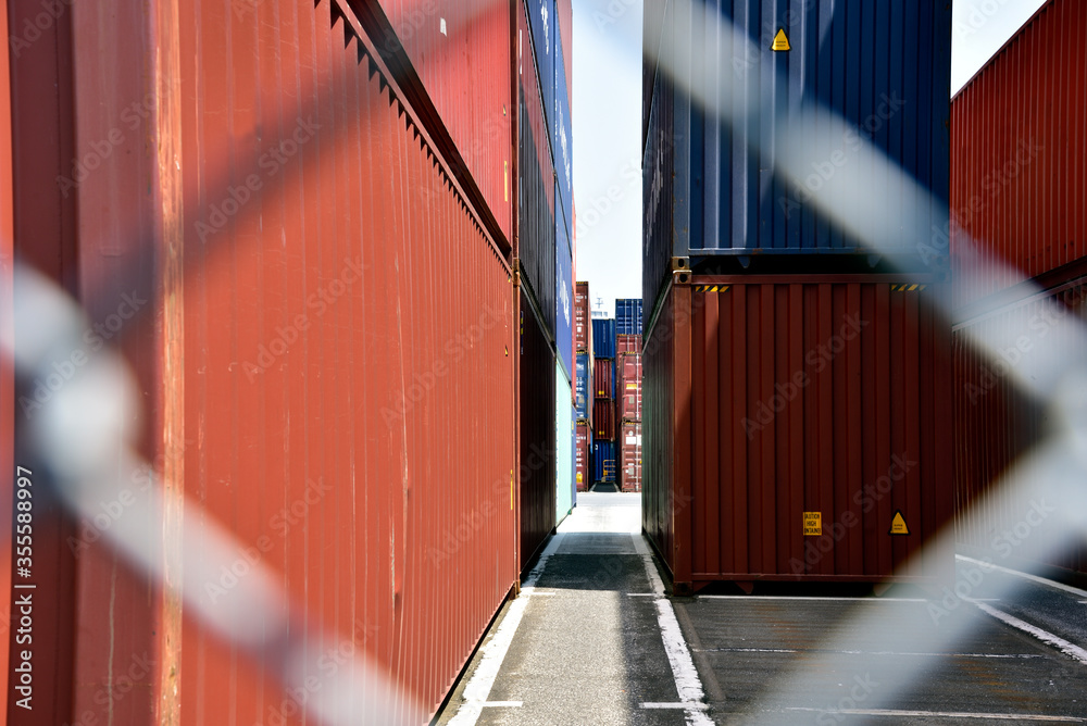 Wire mesh fence enclosing the maritime transport terminal: shipping ...