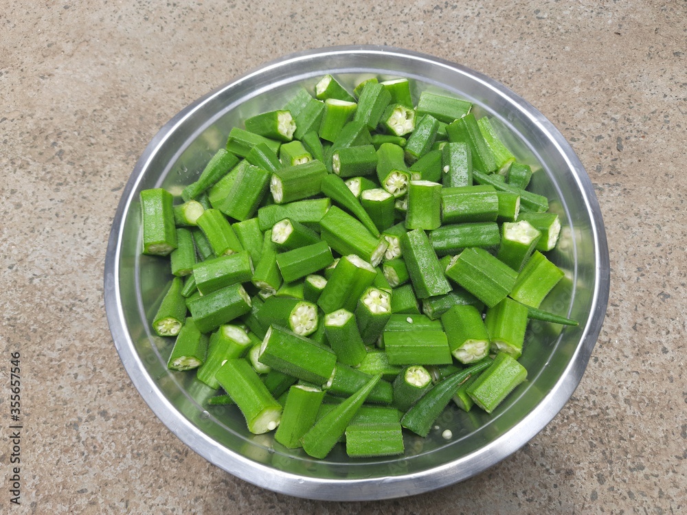 Cutting Okra / lady finger in the bowl. Okra , Abelmoschus esculentus ...