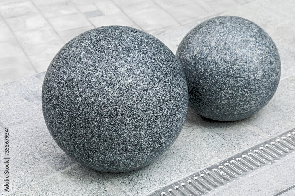 installation of concrete spheres on the sidewalk Stock Photo | Adobe Stock