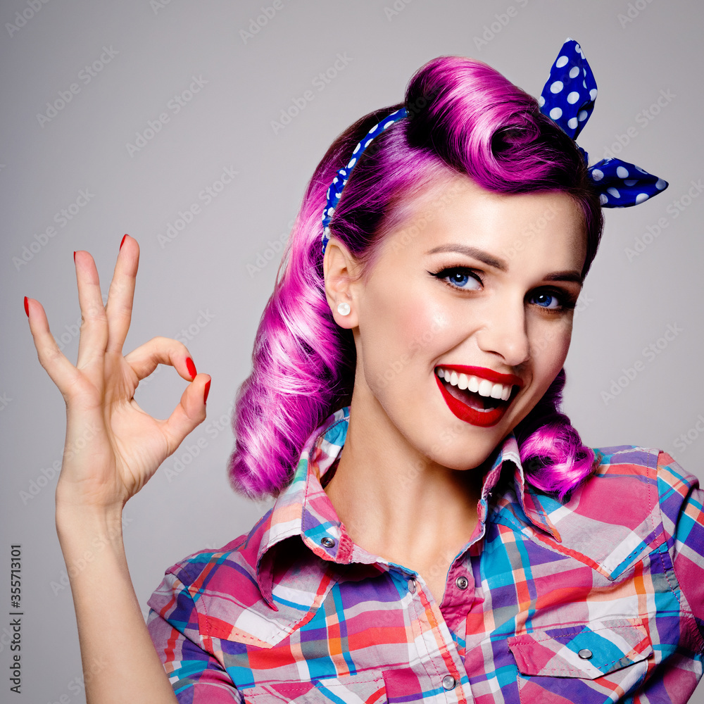 Pin up girl. Portrait of excited happy smiling woman showing ok sign ...
