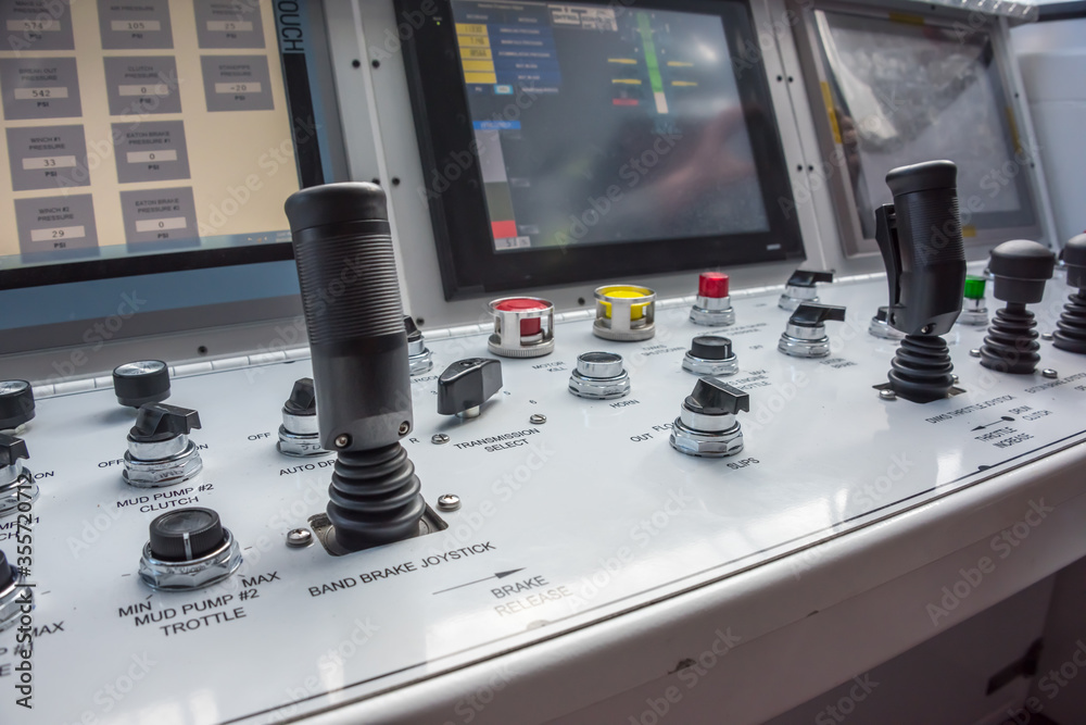 Oil rig computer controls & switches in operators room on rig floor ...