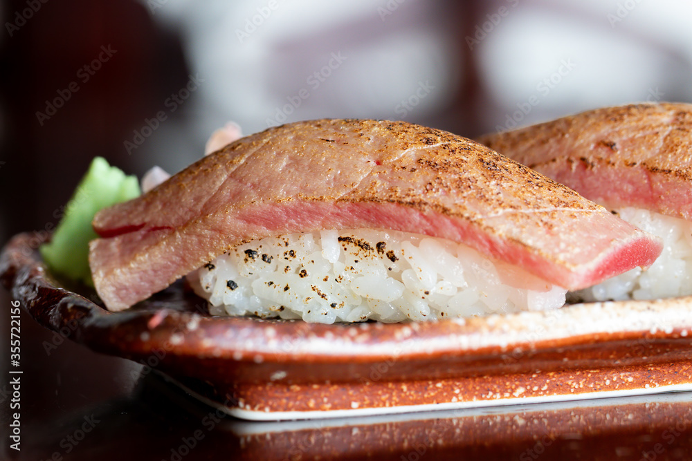 close-up of a single tuna nigiri sushi showing the side view of Tuna ...
