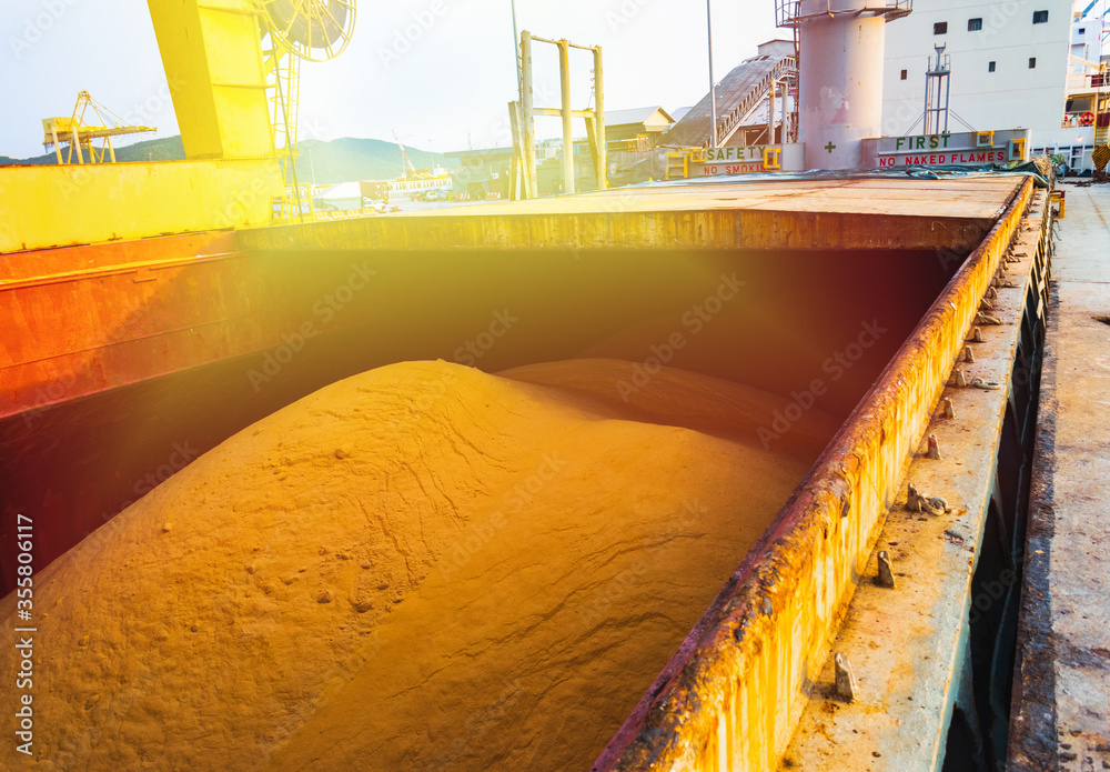 Raw sugar bulk loaded into large vessel hole for export. Sugar bulk ...