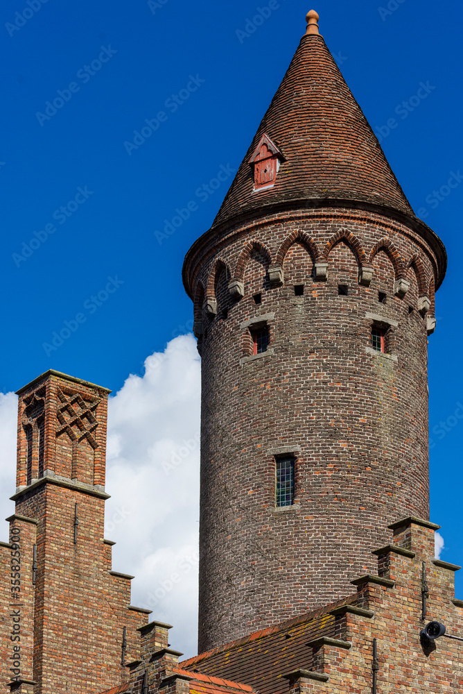 Stepped gable, tower and tall brick chimney on the roofs of houses in ...