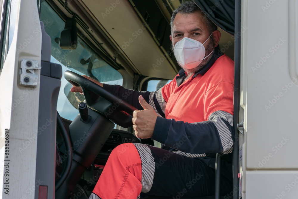 Truck driver with face mask in the cockpit making the ok sign Stock ...