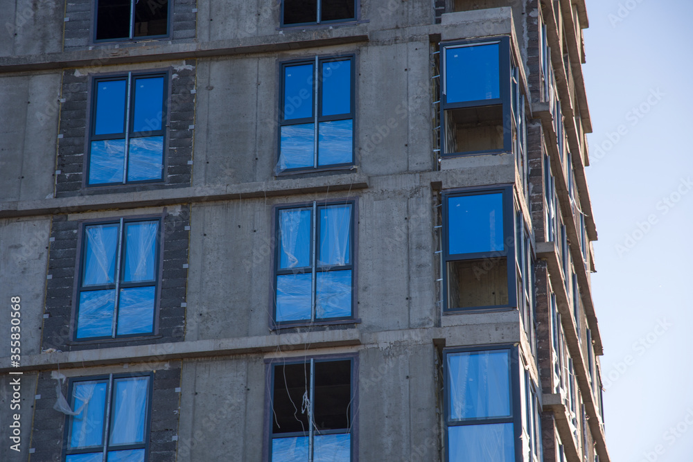 Installation of double-glazed windows in a multi-storey building at a ...