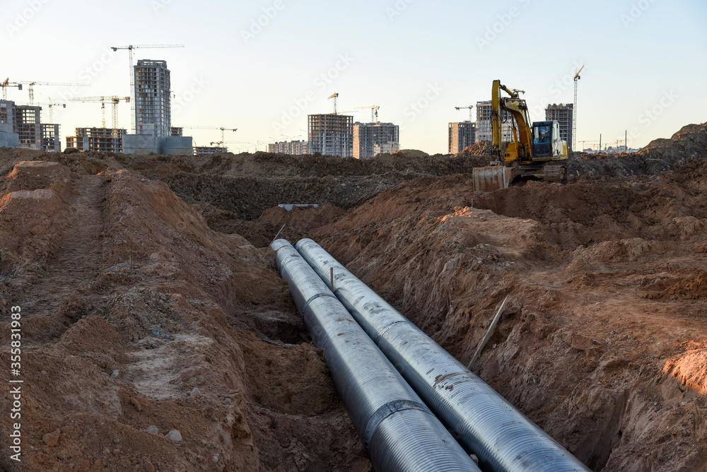 Excavator during construction of main water supply pipeline. Laying ...