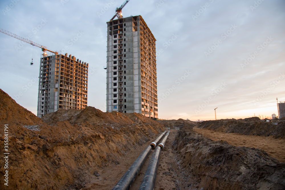 Drainage pipes at the large scale construction site against tower ...