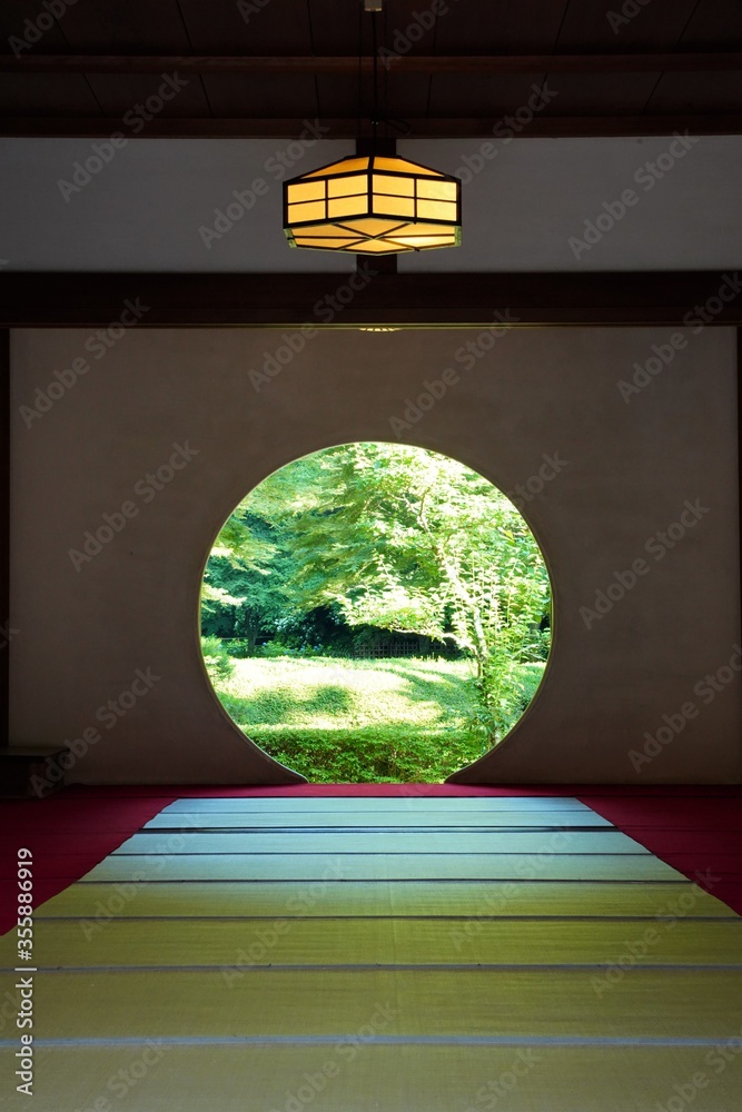 You can see Karesansui Japanese style garden though the round window ...