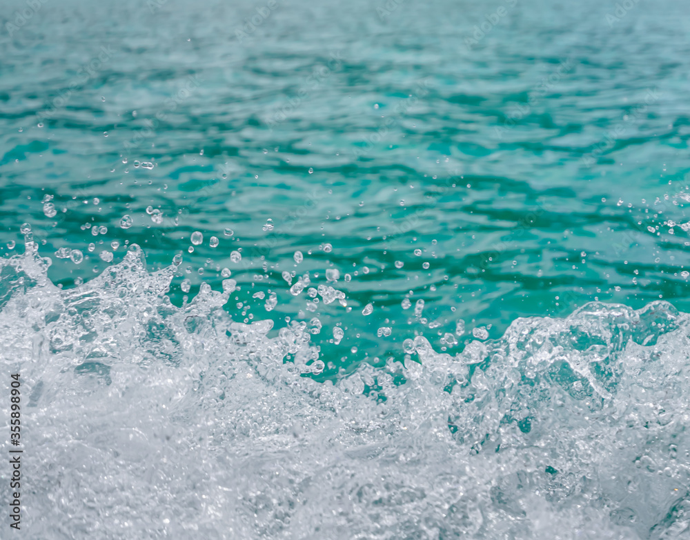 The emerald green water splashes while the boat sails in the ...