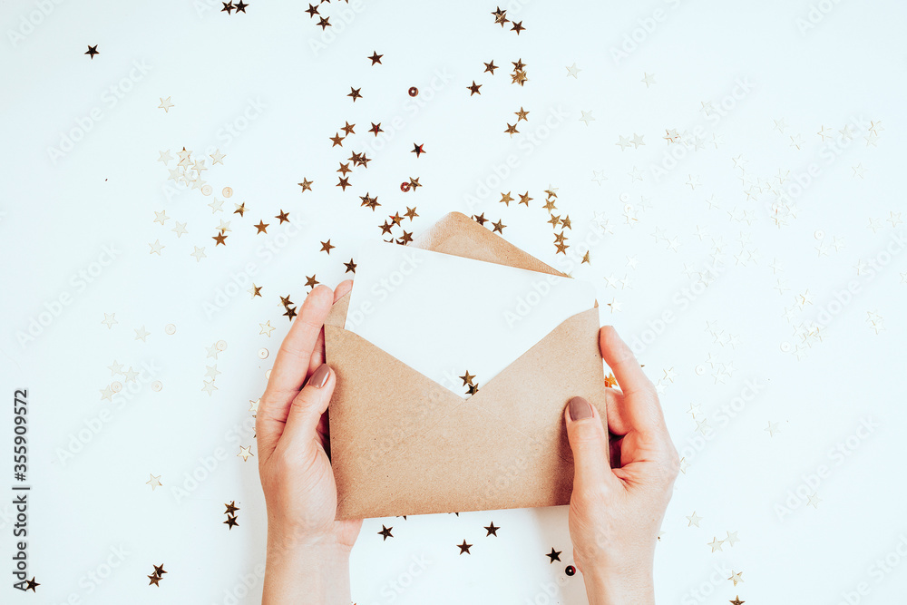 Female's hands with gift envelope with blank white card mockup over ...