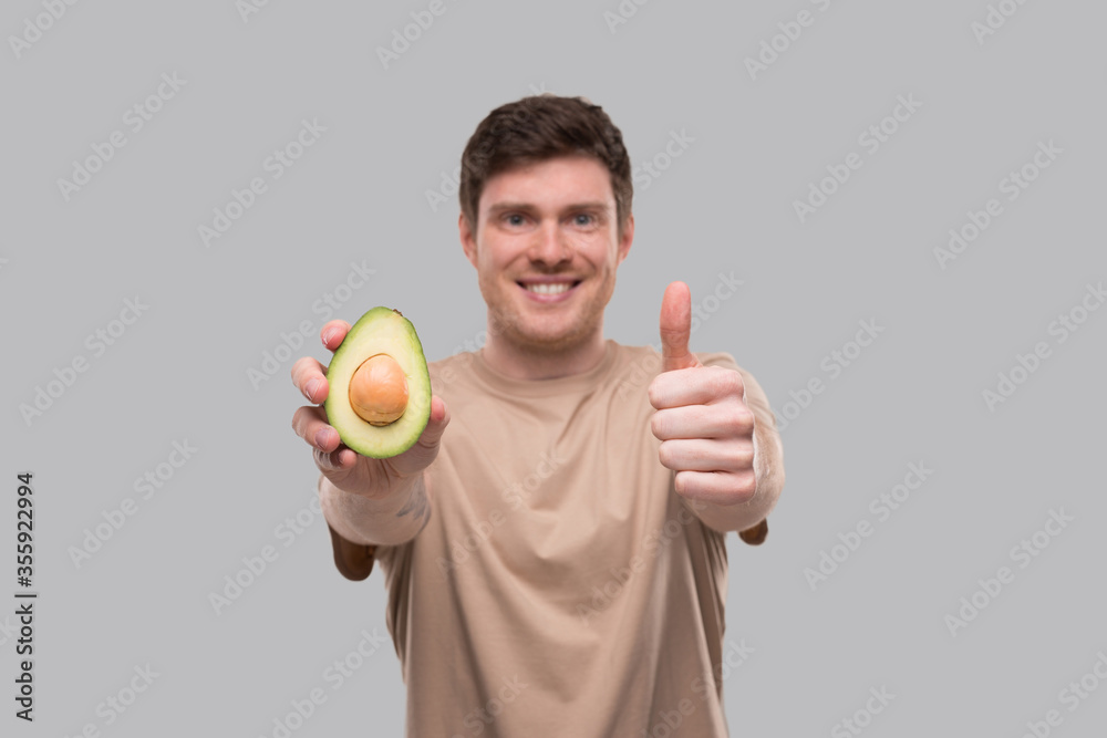 Man Showing Avocado and Thumb Up Close Up Isolated. Avocado Cut in Half ...