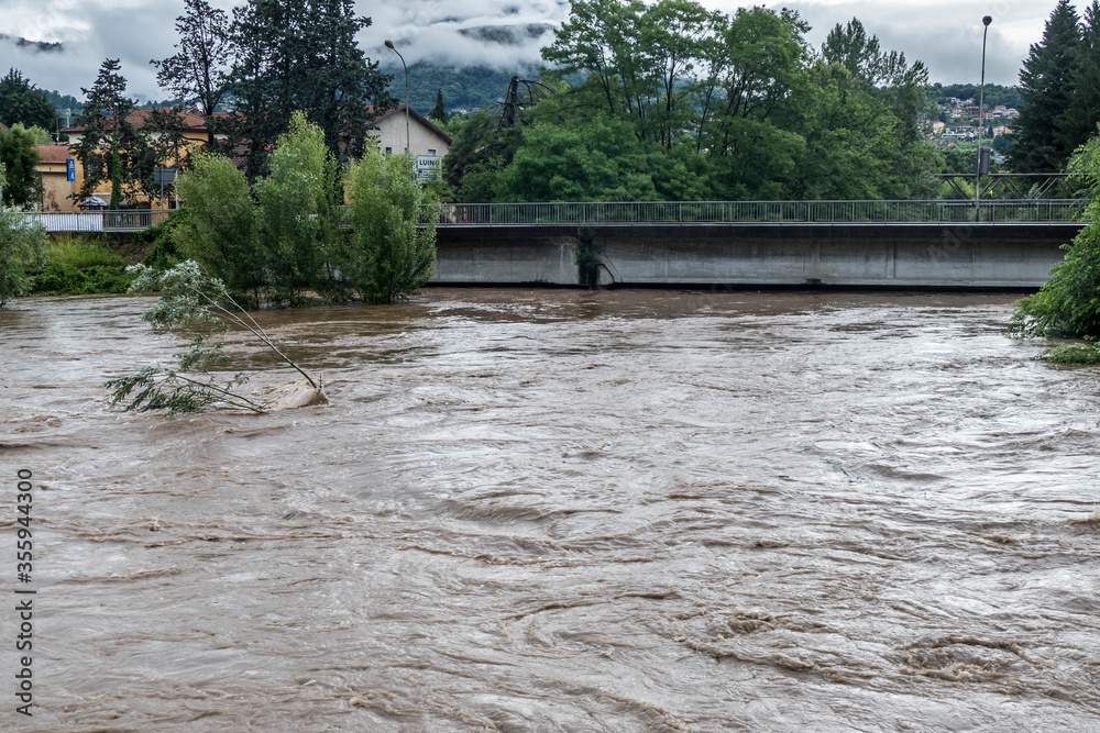 Climate change: flooding river hits the bridge after a storm in Luino ...