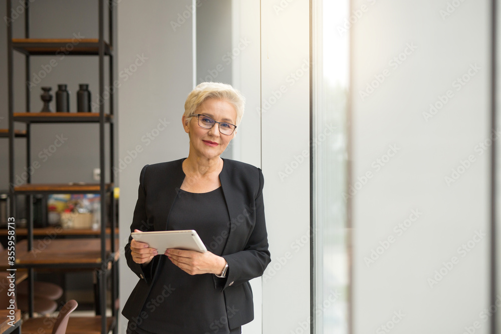 beautiful stylish woman aged with a tablet in her hands Stock Photo ...