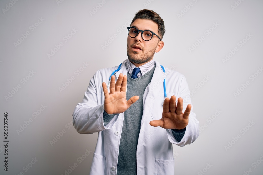 Young doctor man with blue eyes wearing medical coat and stethoscope ...