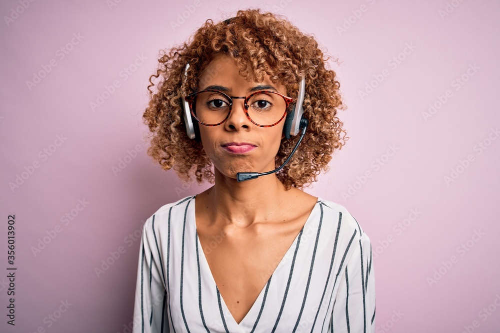 African american curly call center agent woman working using headset ...