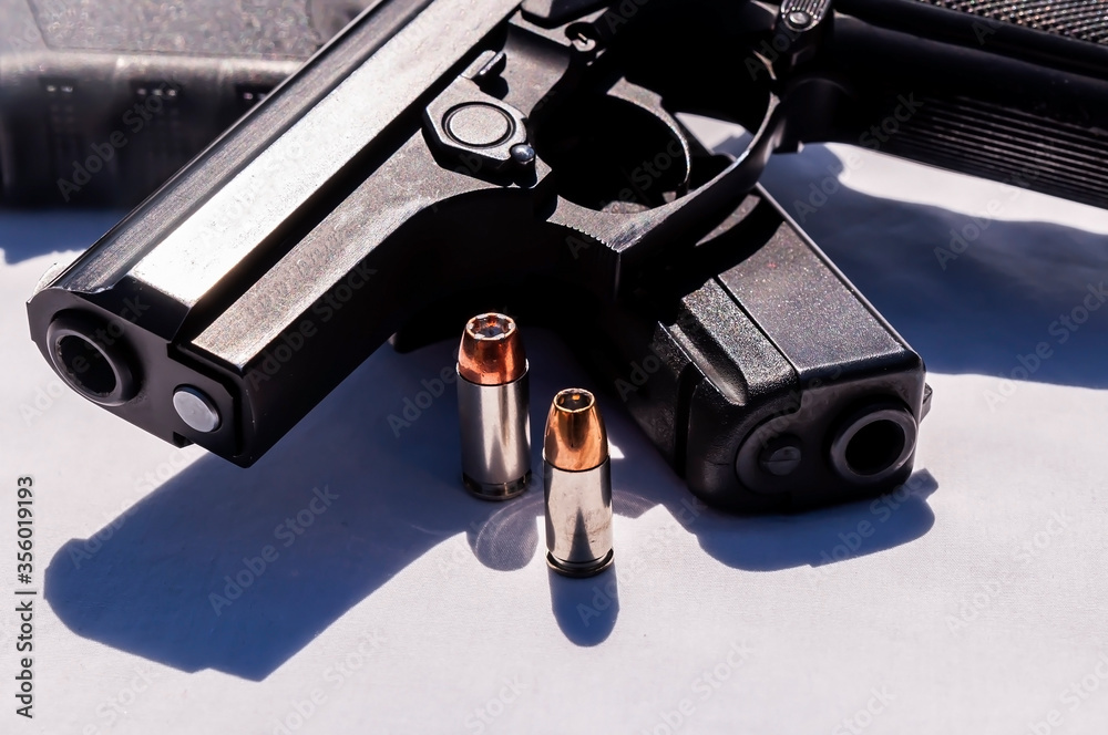 Two black semi automatic pistols, a 40 caliber and a 9mm with a hollow ...