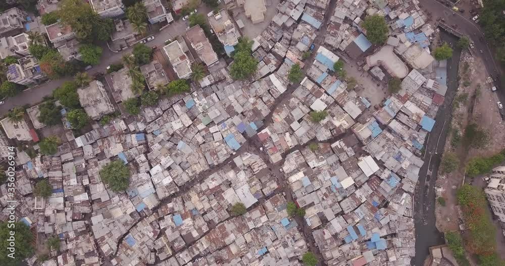 Slowly aerial rotating shot with top down view above the rooftops of ...