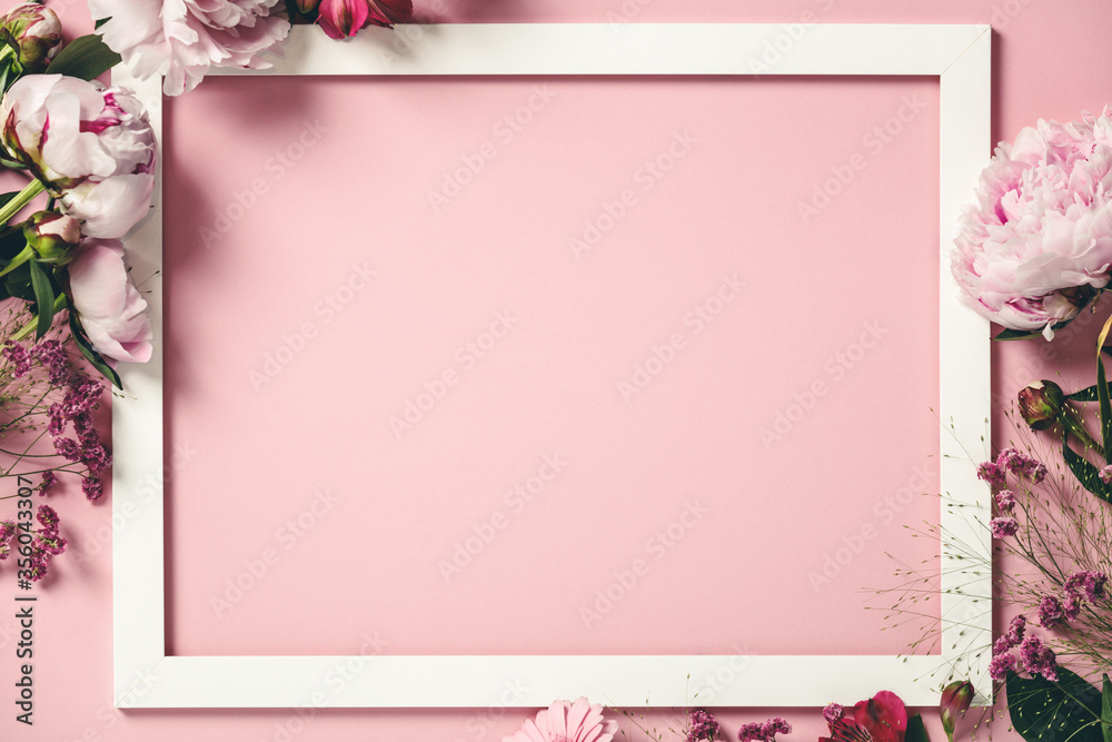 Assorted pink flower and white frame border on pink background, flat ...