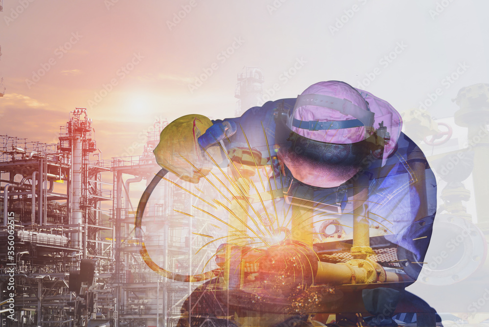 Double exposure Industry worker at the factory welding with spark light ...