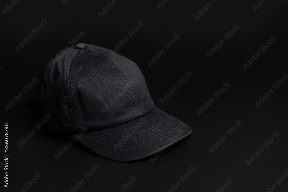 Black cloth cap / hat on the dark black background. Stock Photo | Adobe ...