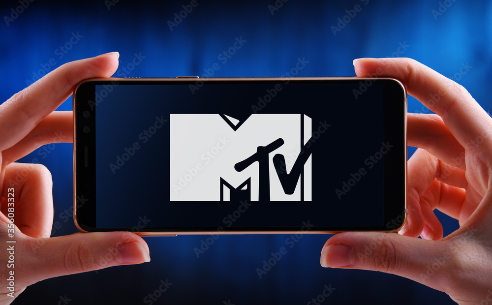 Hand holding smartphone displaying logo of MTV Stock Photo | Adobe Stock