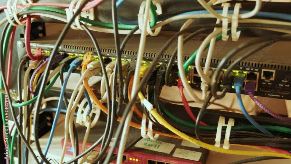 Network switch and ethernet cable in rack cabinet. Network connection ...