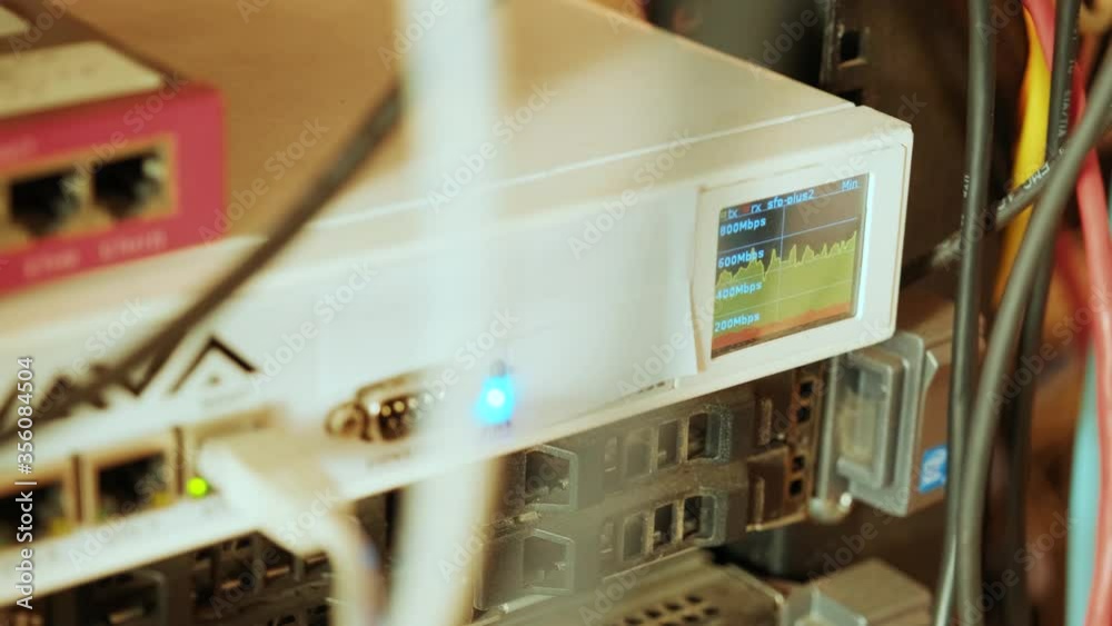 Network switch and ethernet cable in rack cabinet. Network connection ...