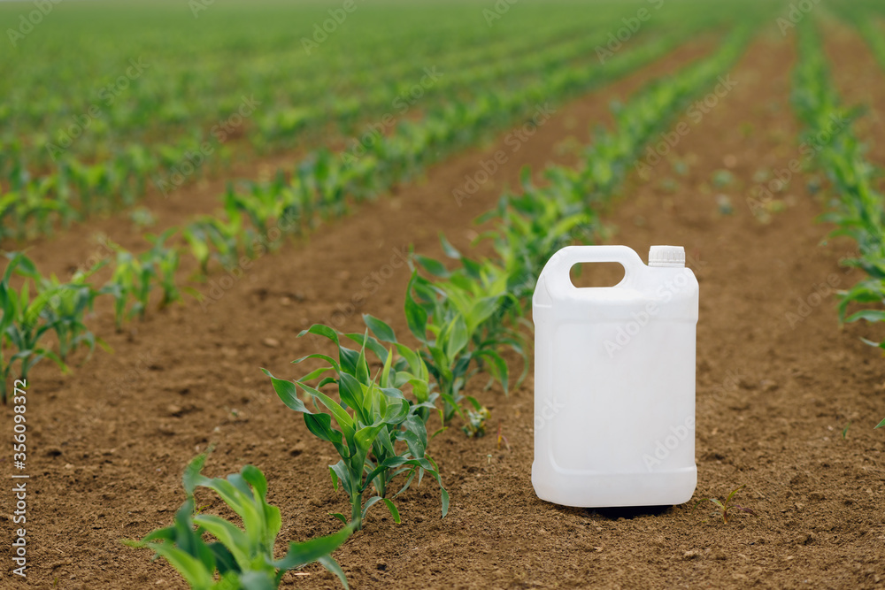 Corn pesticide canister in field, mock up image Stock Photo | Adobe Stock