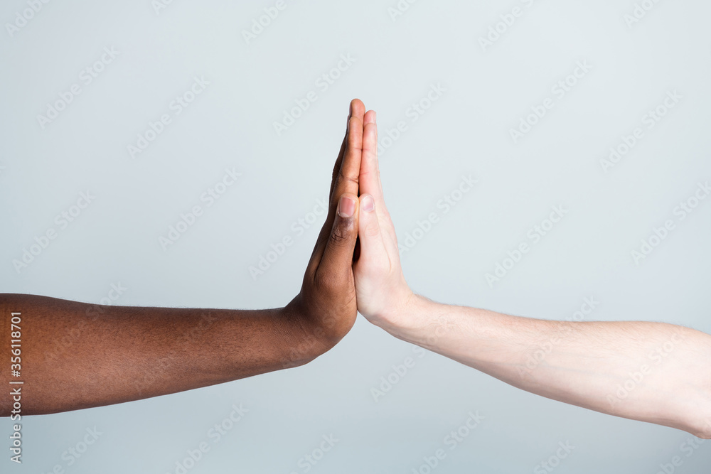 Closeup photo of two arms clap giving five different race multinational ...