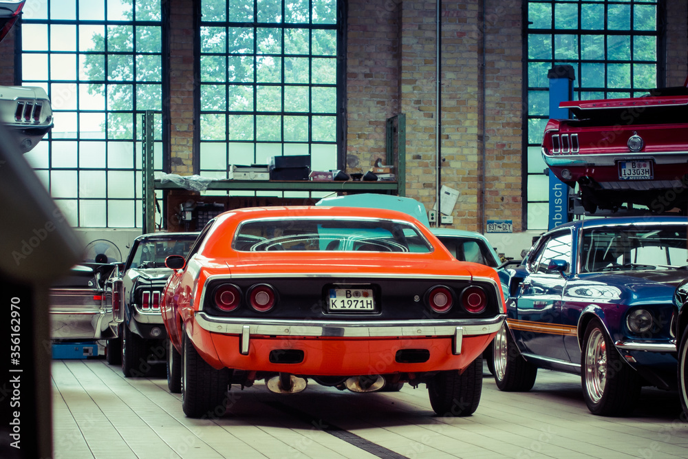 Oldtimer Garage with Plymouth Barracuda and Ford Mustang Stock Photo ...