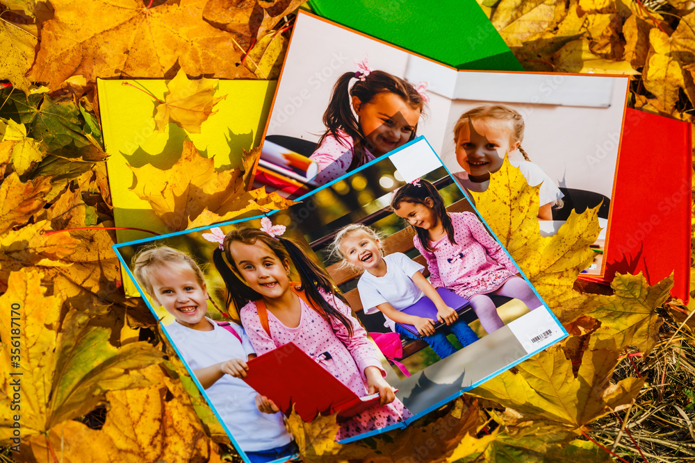 school photo book on the yellow leaves top view. rustick photo of ...